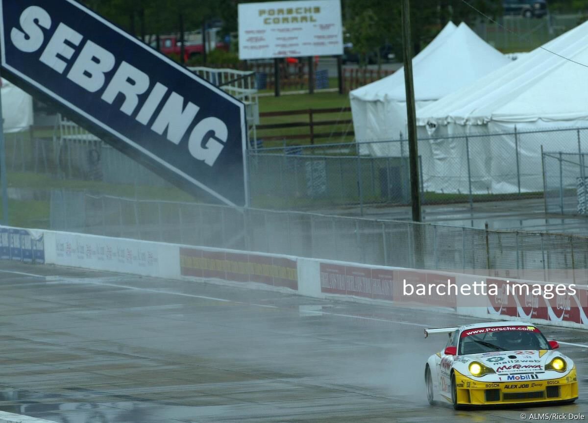 One of the Alex Job Racing Porsches navigates the wet front ...